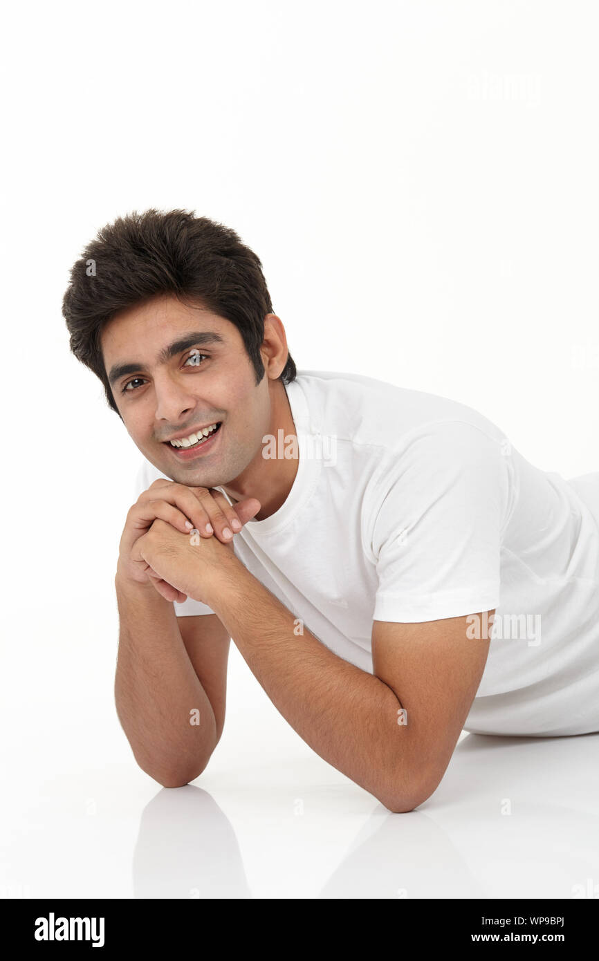 Young man lying down on the floor Stock Photo - Alamy