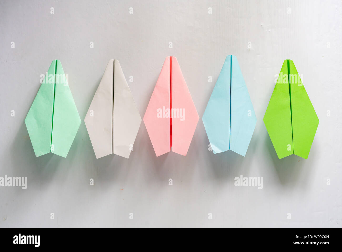 row of some color paper planes, handmade origami on the tables Stock ...
