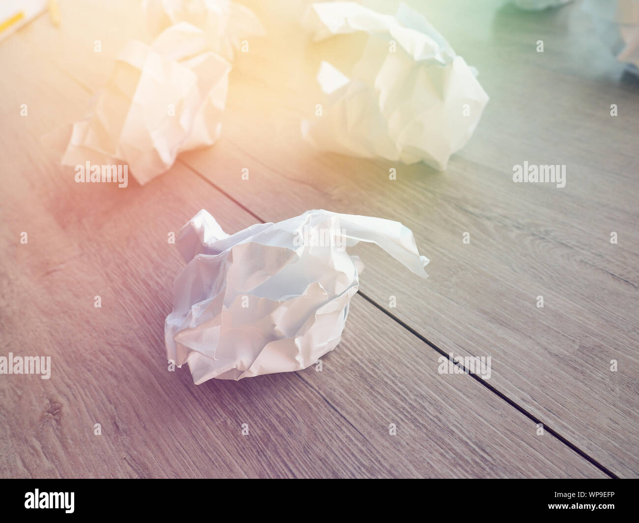 Writing concept - crumpled up paper wads with a sheet of white paper ...