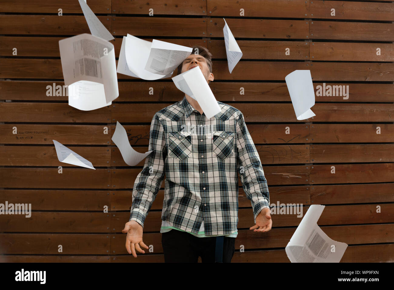 young stressed man throw crumpled paper files in the air, freedom ...