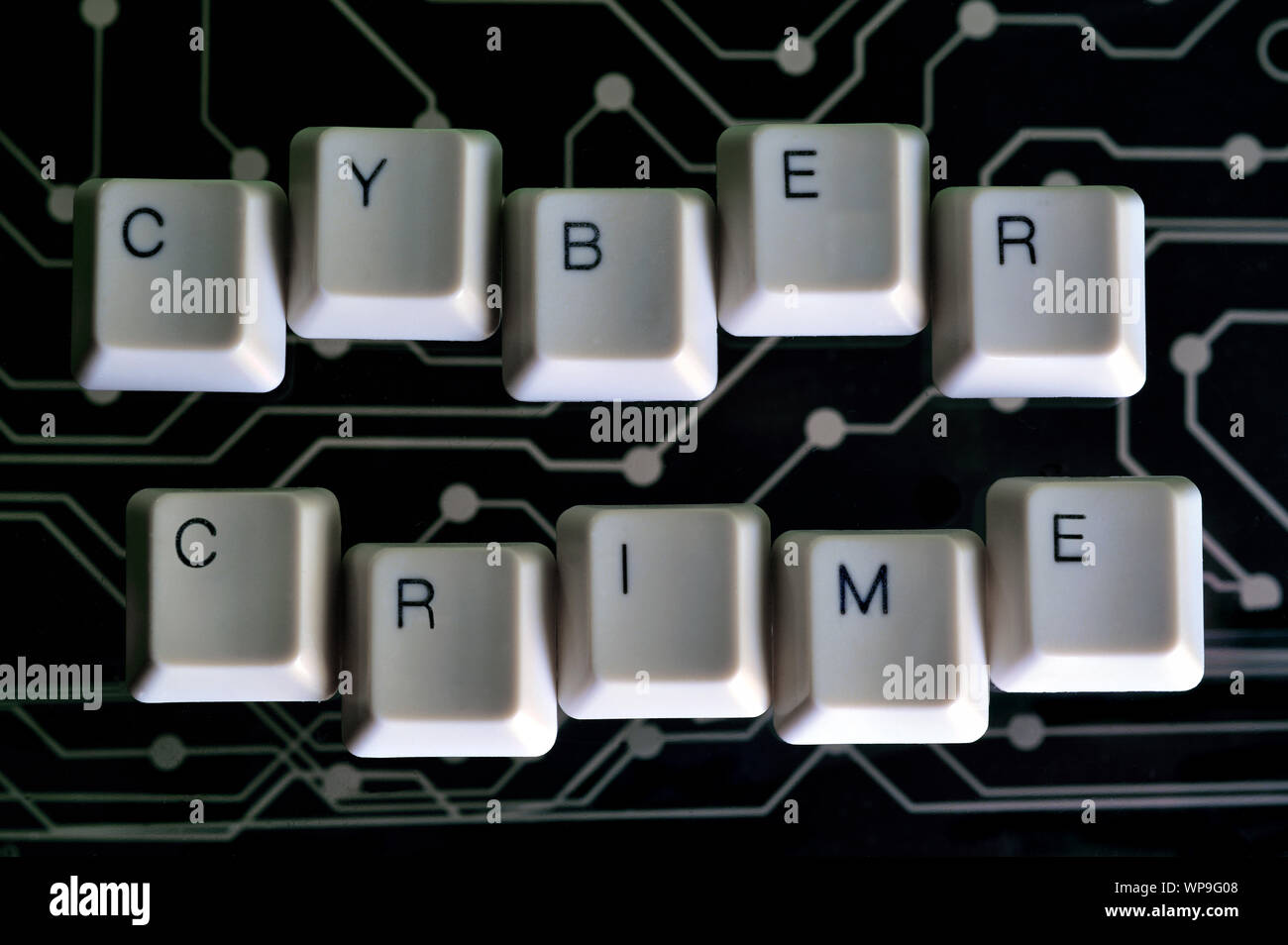 Keyboard keys form the word CYBER CRIME on black electric circuit in ...
