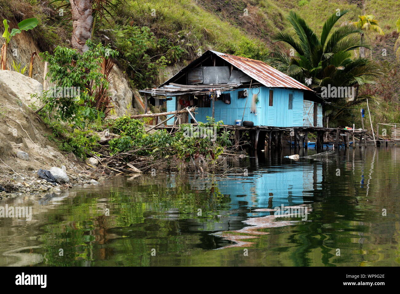 Blue stilt house in Doyo Lama, Lake Sentani, West Papua, Indonesia ...