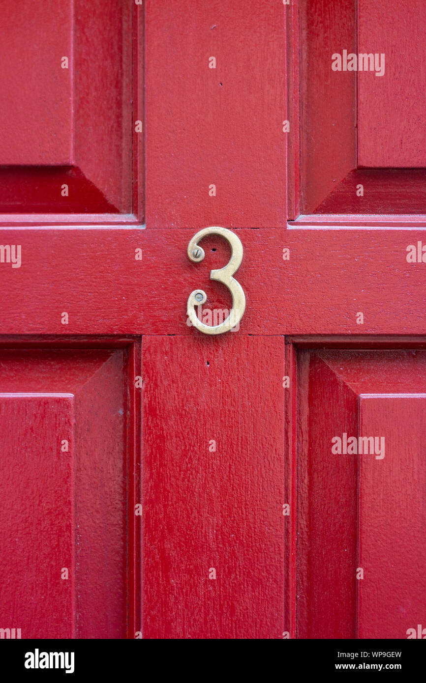 House number 3 on a bright red wooden front door Stock Photo - Alamy