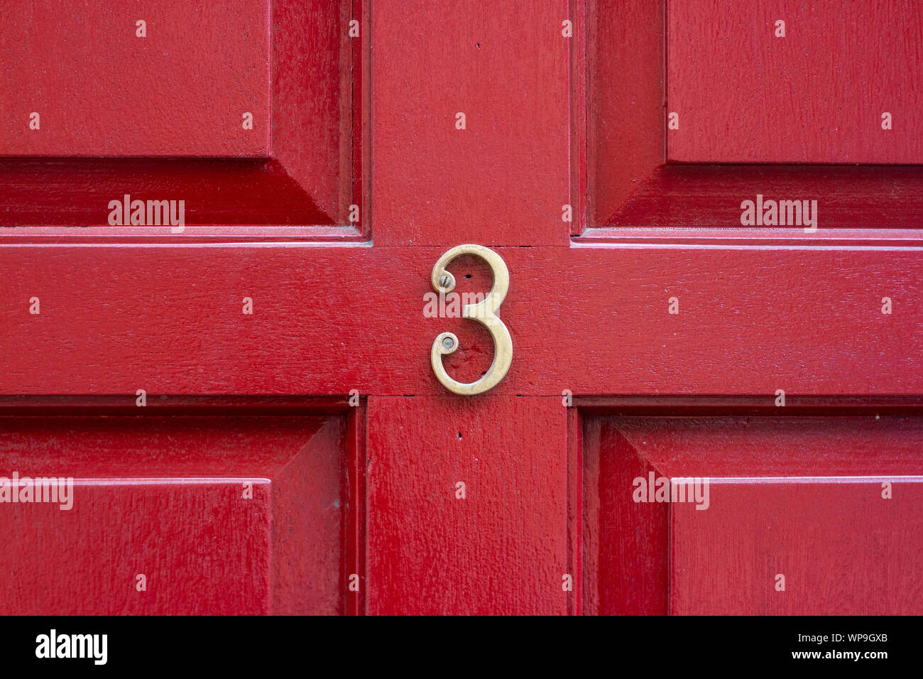 House number 3 on a bright red wooden front door Stock Photo - Alamy