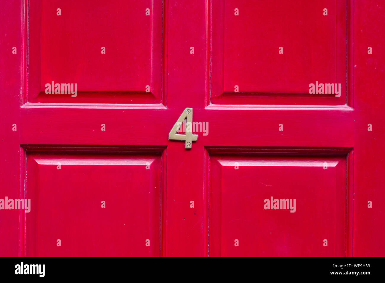 House number 4 on a bright red wooden front door Stock Photo - Alamy