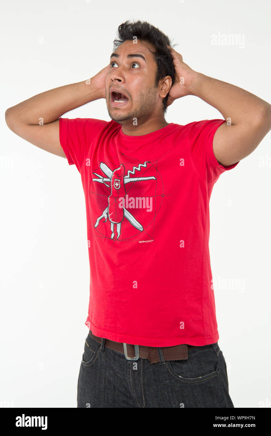 Young man looking shocked Stock Photo - Alamy