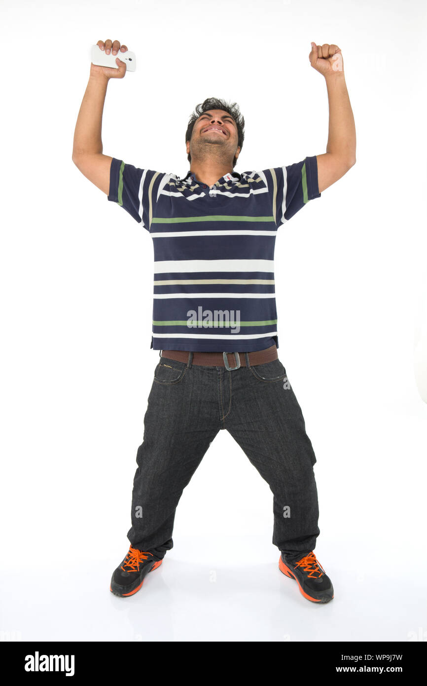 Young man celebrating his success Stock Photo - Alamy