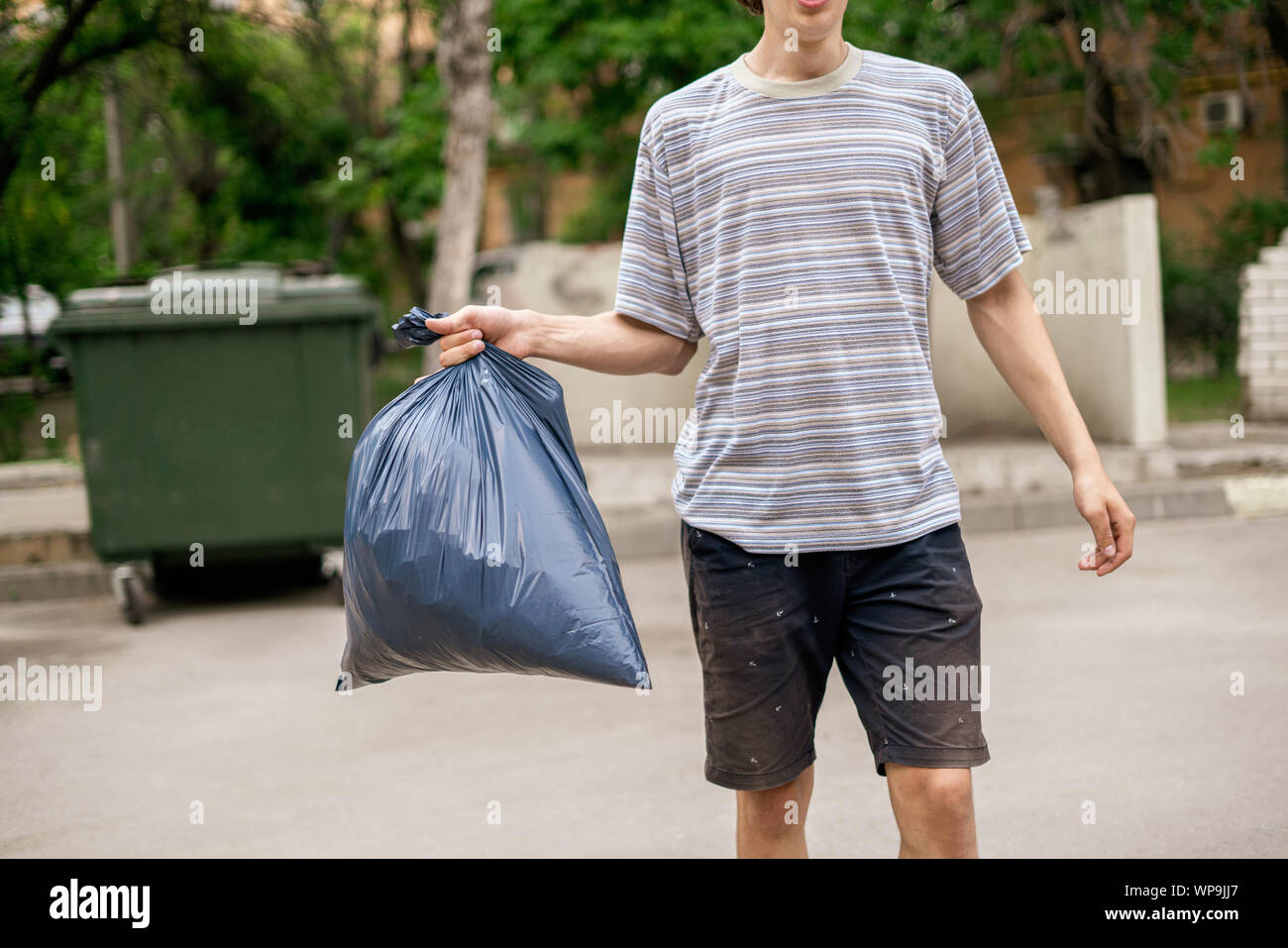 Man is carrying the garbage bag hi-res stock photography and images - Alamy