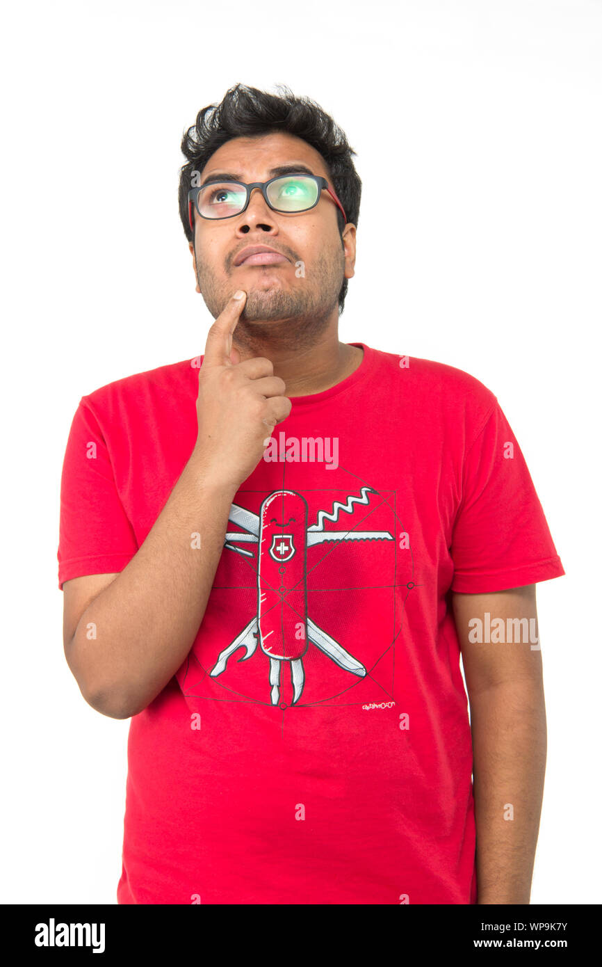 Young man thinking with his finger on chin Stock Photo - Alamy