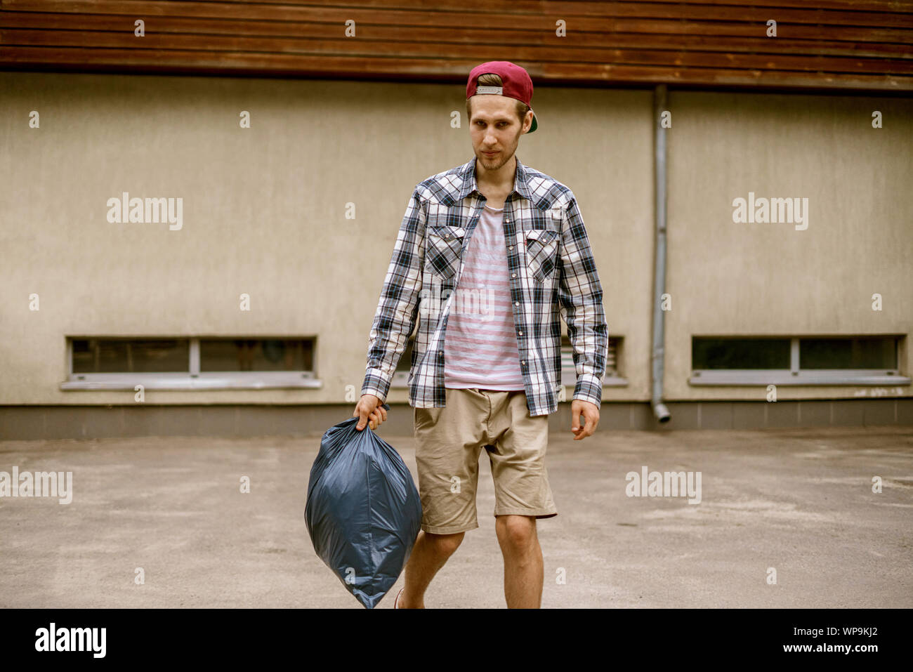 Man carrying trash bag hi-res stock photography and images - Alamy