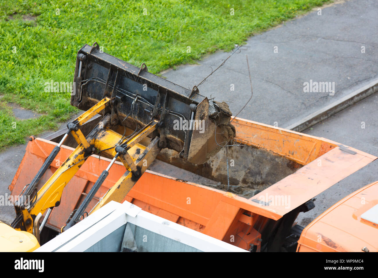 Loading construction debris into the truck for removal to the landfill ...