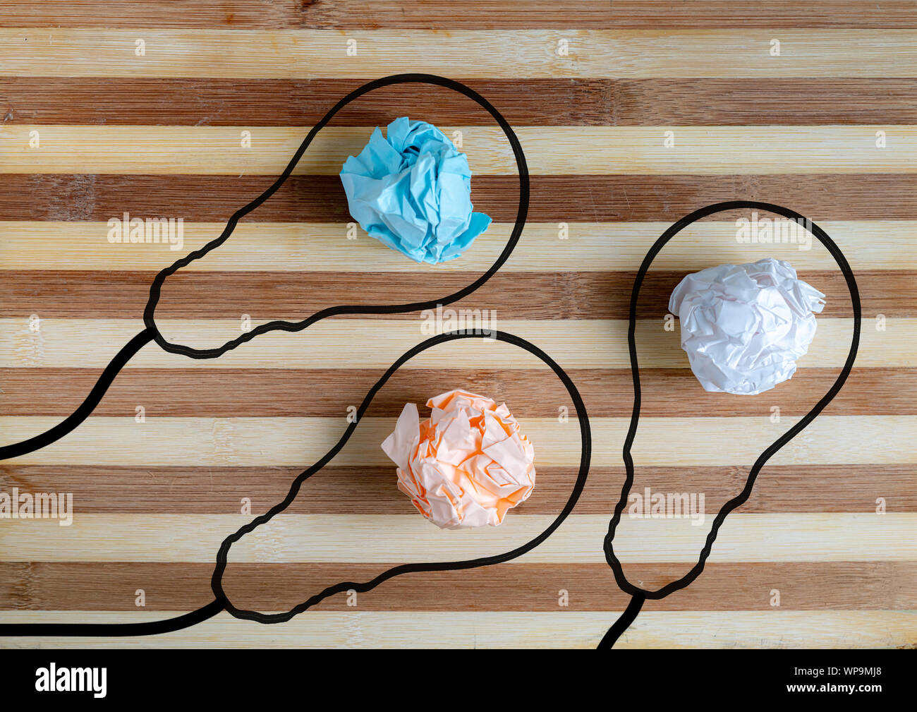 several light bulbs made of color paper balls on the tables Stock Photo ...