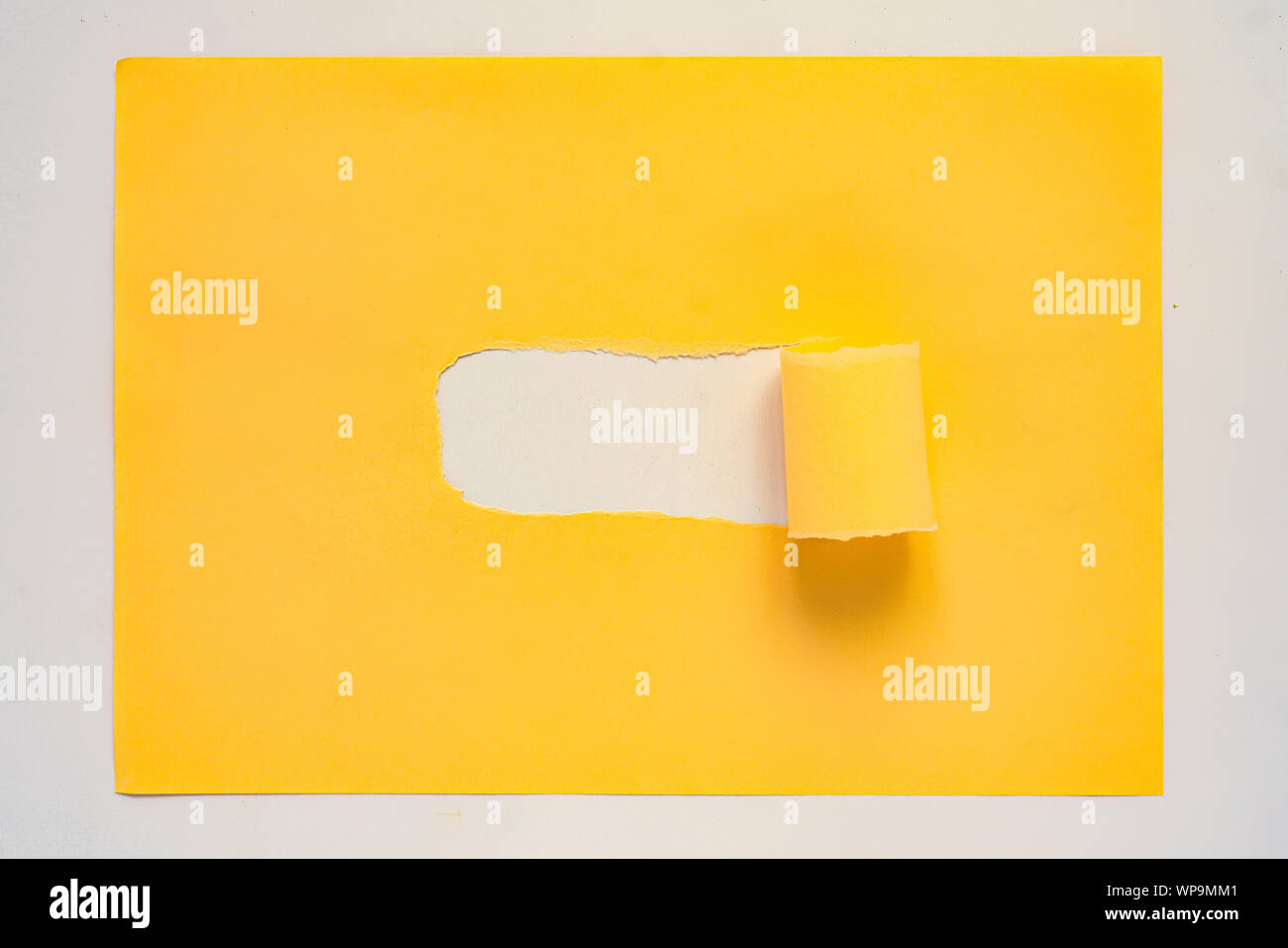 hole in a paper with torn side with a place for text, color surfaces ...