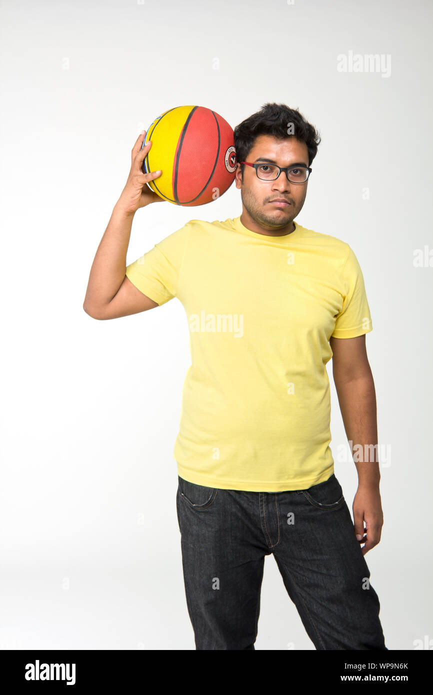 Sad young man holding a basketball Stock Photo - Alamy