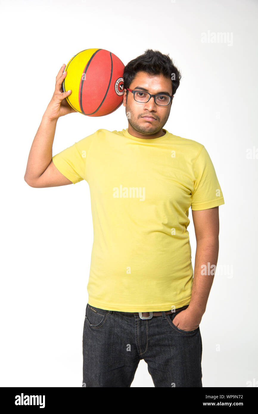 Sad young man holding a basketball Stock Photo - Alamy
