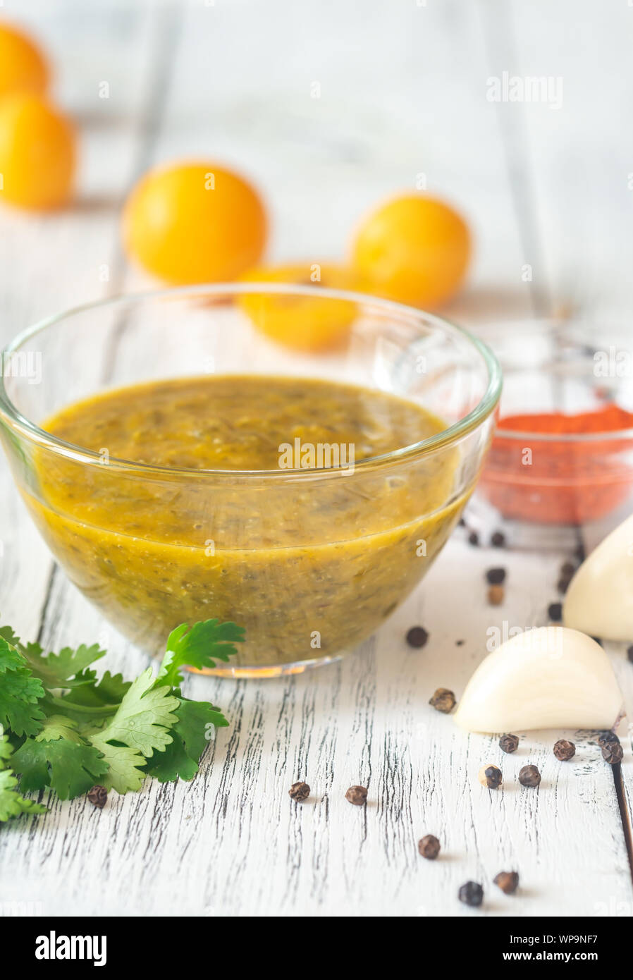 Bowl of tkemali - Georgian plum sauce with the ingredients Stock Photo ...