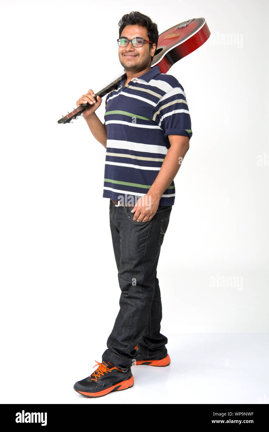 Young man carrying guitar hi-res stock photography and images - Alamy