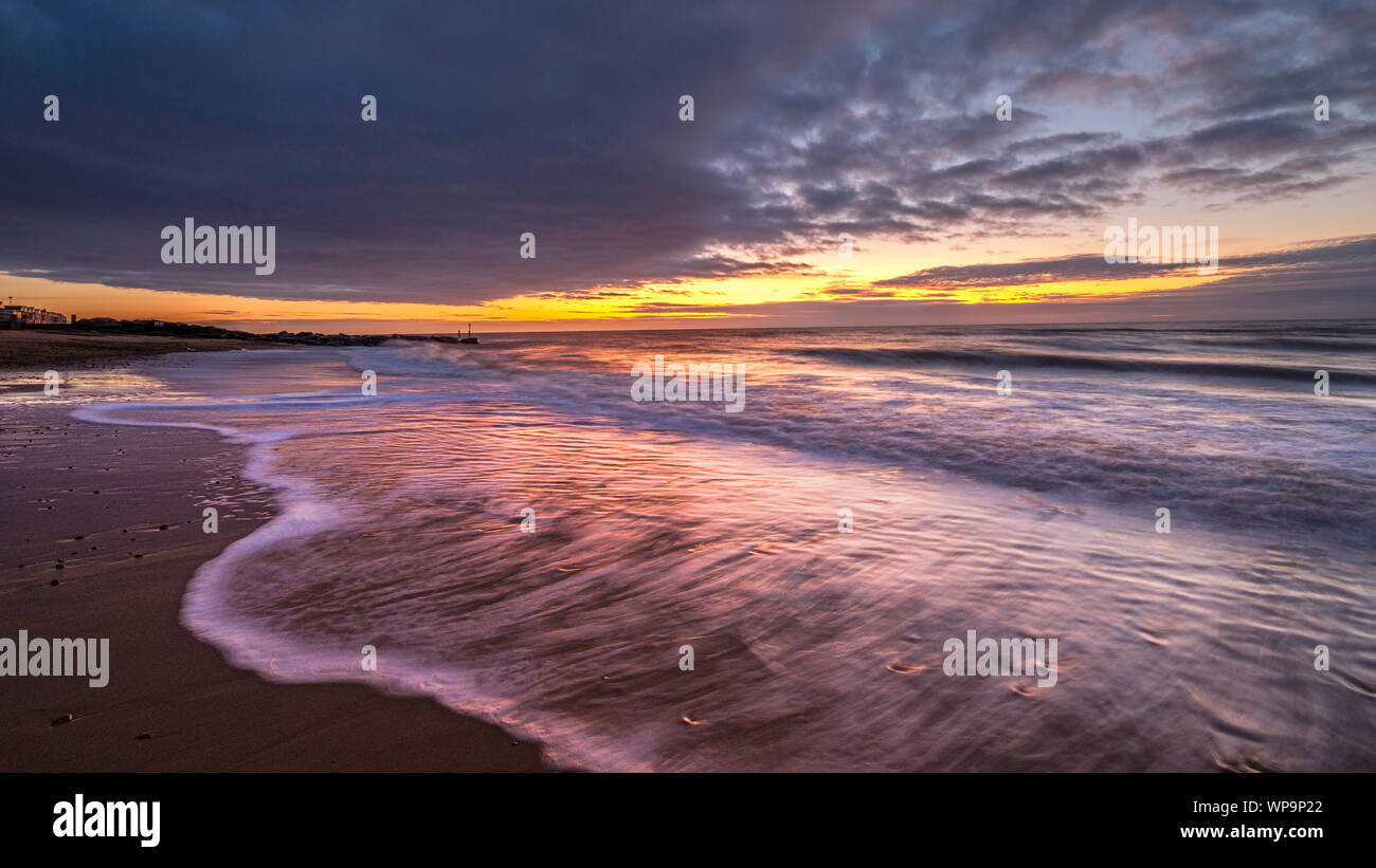 Dawn breaks at a beautiful British beach Stock Photo - Alamy