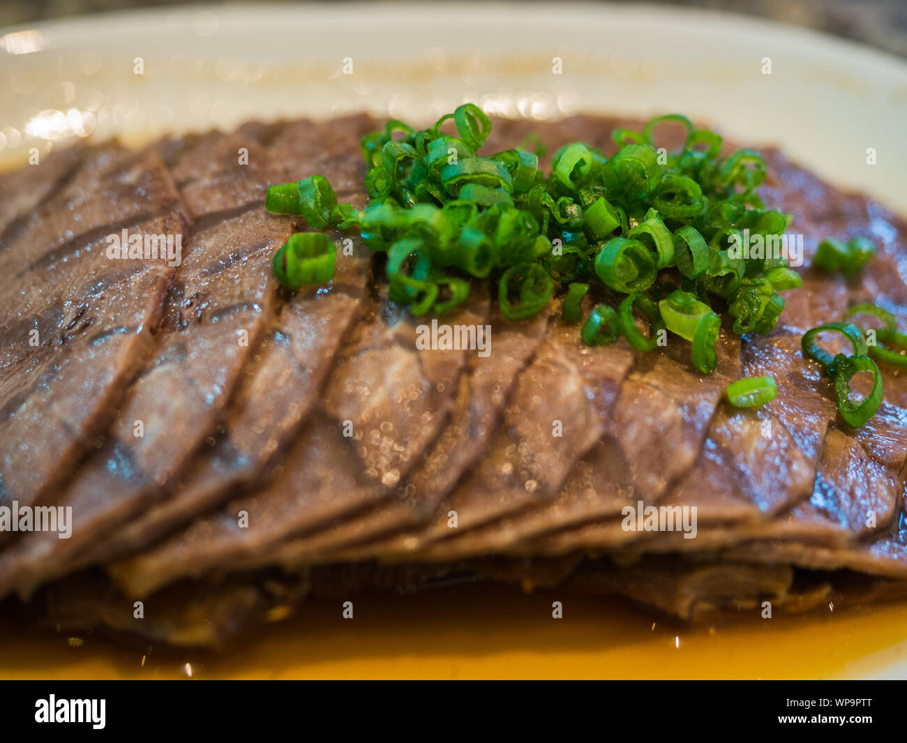 braised sichuan sliced beef with spring onion Stock Photo - Alamy