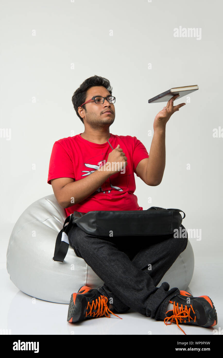 College student balancing a book on his finger Stock Photo - Alamy