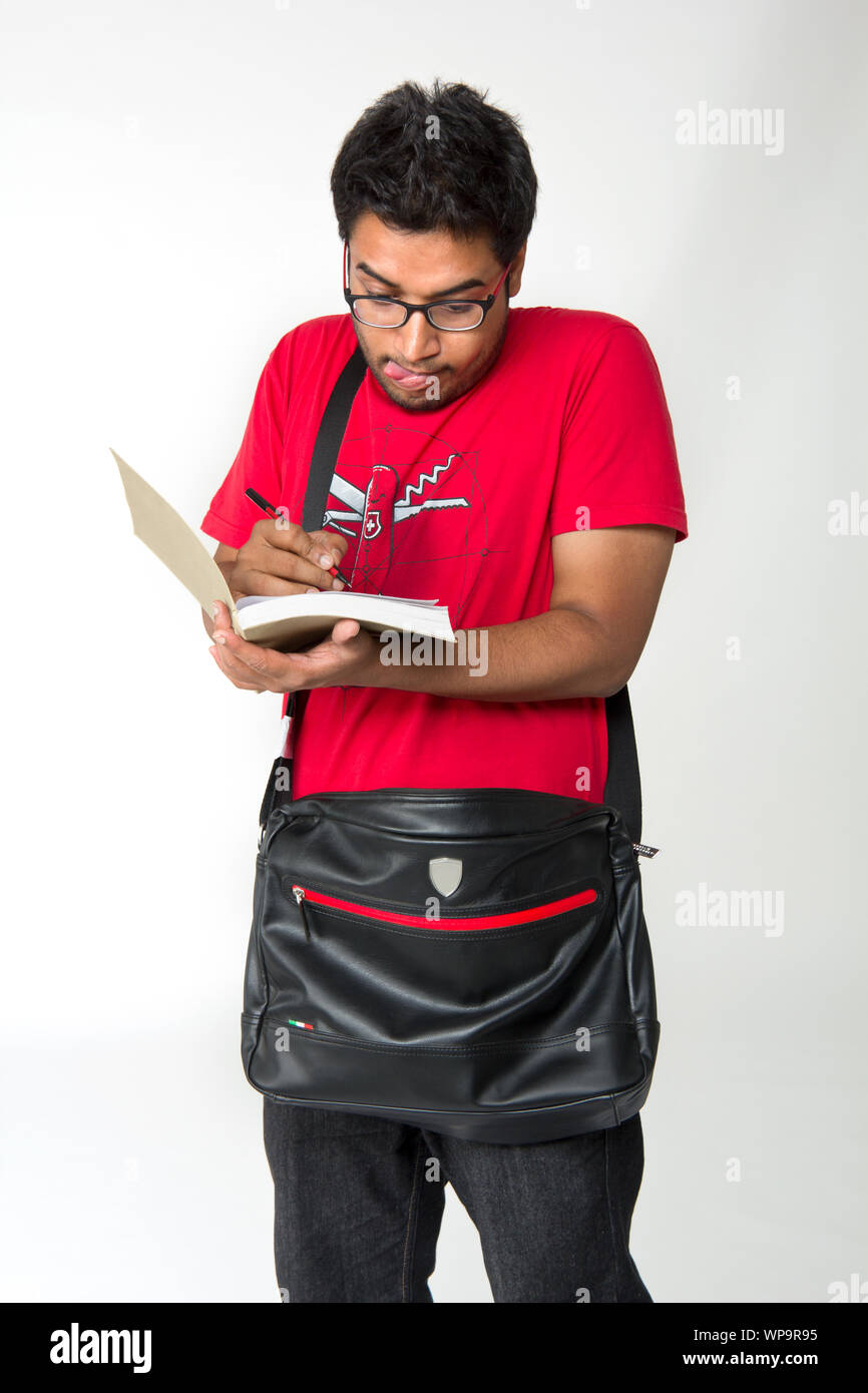 College student studying a book Stock Photo - Alamy