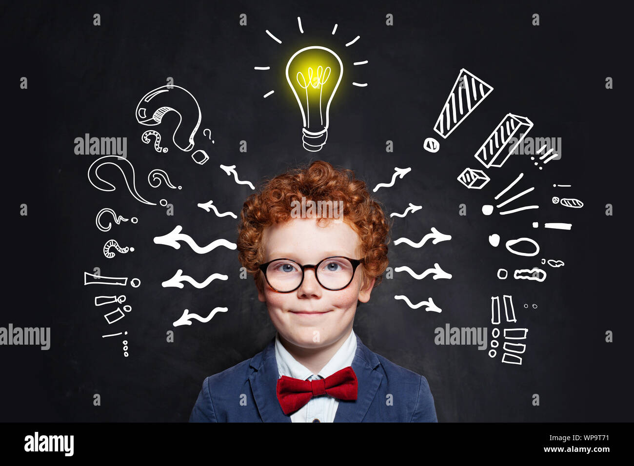 Student boy with lightbulb on blackboard background, idea concept Stock ...