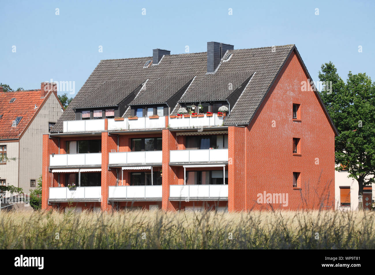 Modern multi-family house in brick with balconies, backside Stock Photo ...