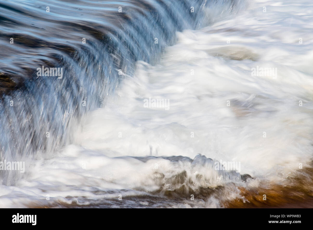 Strong afternoon, incoming tide with waves crashing on a tidal pool ...