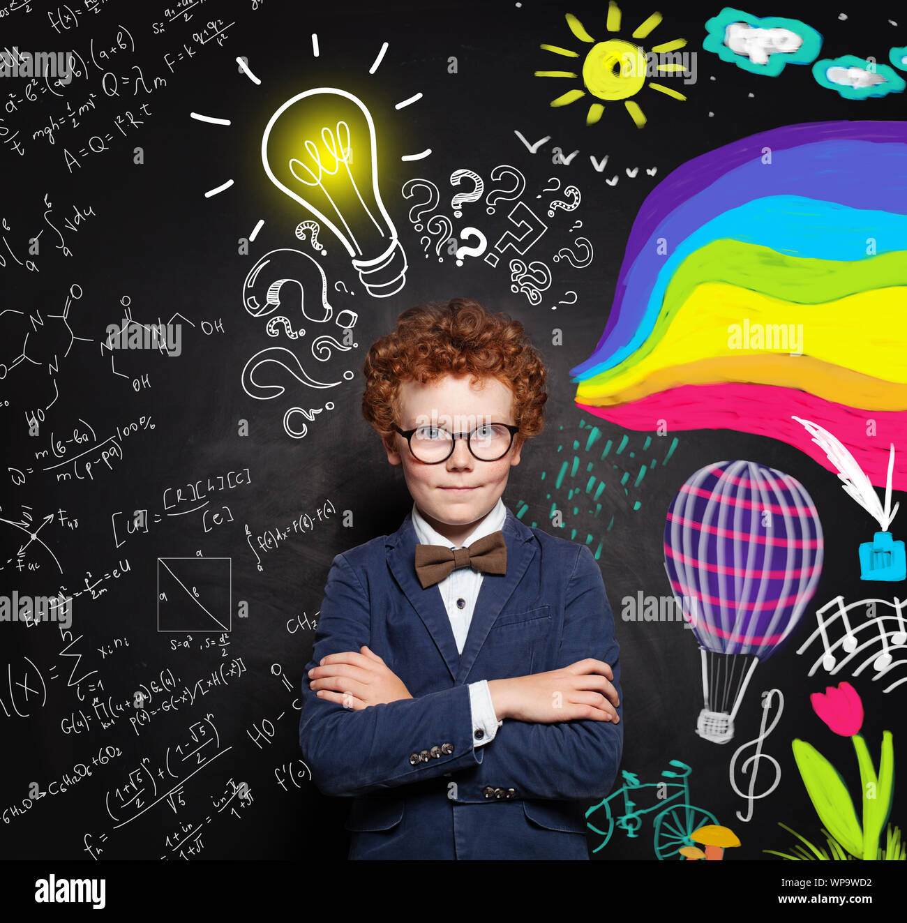 Successful clever child boy with ginger hair, glasses and crossed arms ...