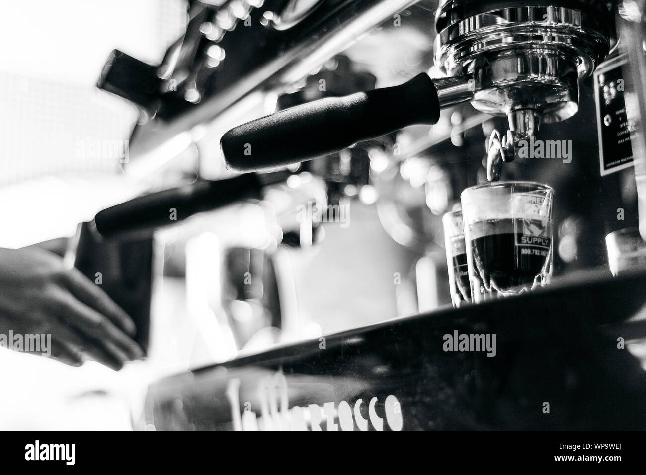 making espresso coffee BW black and white close up detail with modern ...