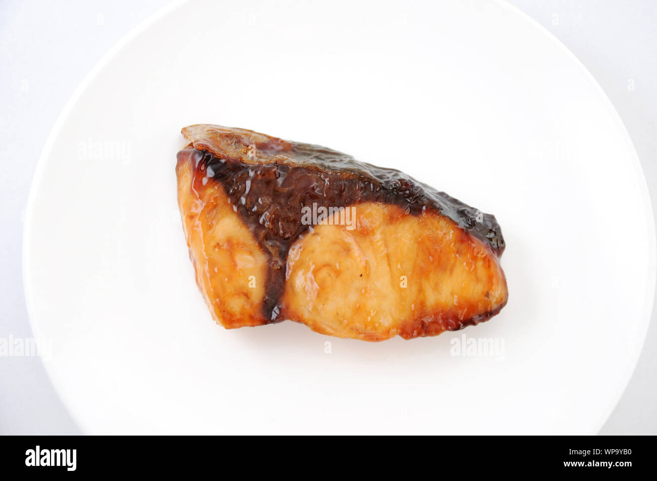 broiled teriyaki fish Japanese amberjack on plate isolated on white ...