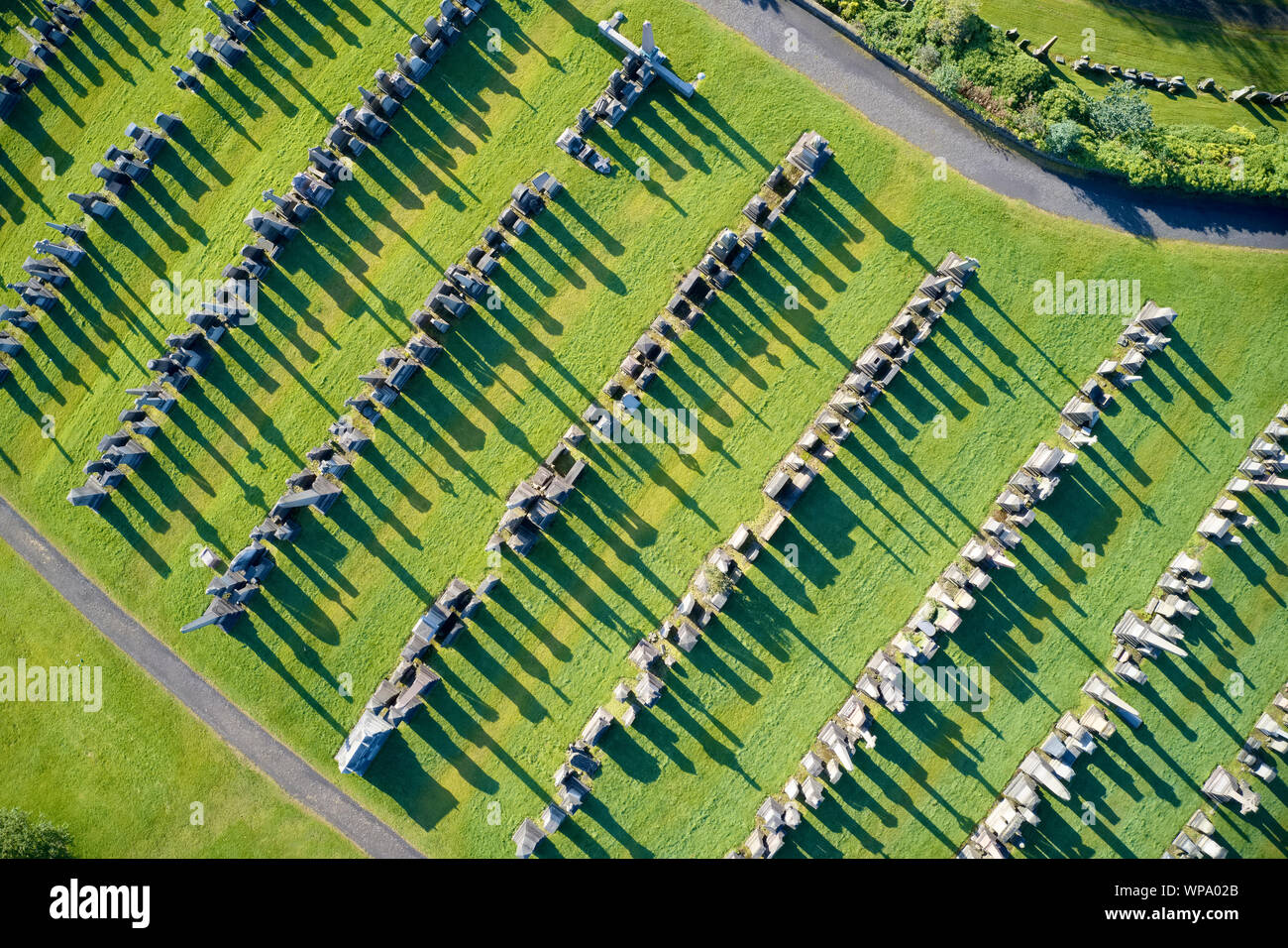 Graveyard necropolis with many headstones aerial view long shadows from ...