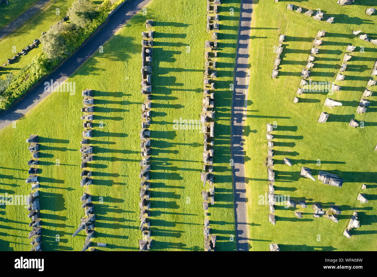 Graveyard necropolis with many headstones aerial view long shadows from ...