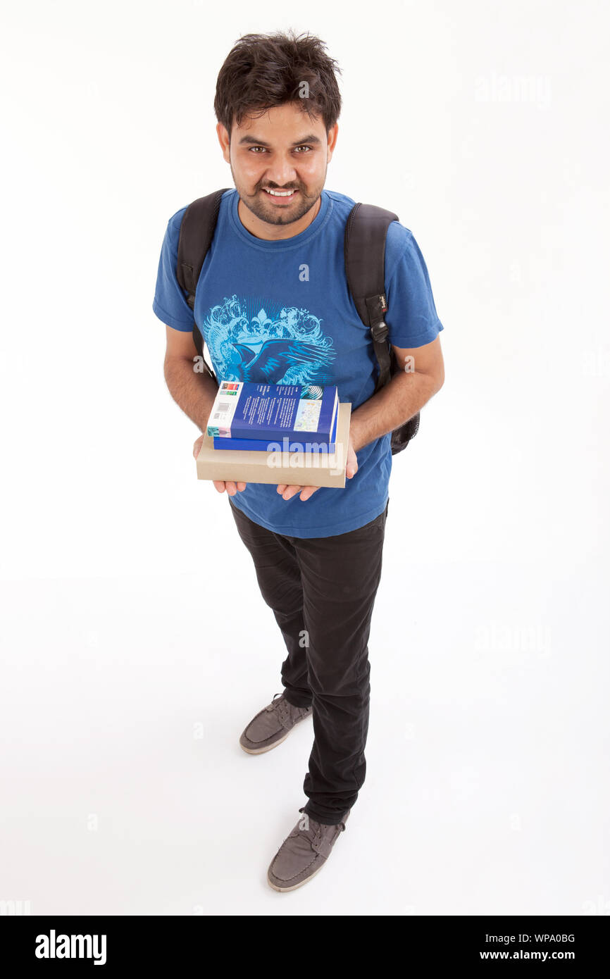 College student standing with books and backpack Stock Photo - Alamy