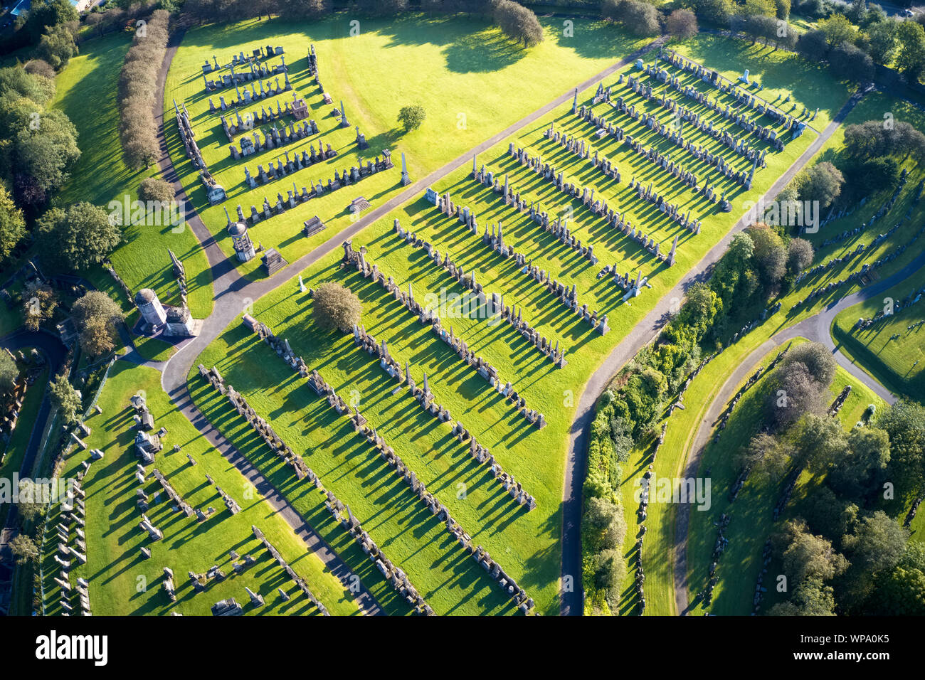 Graveyard necropolis with many headstones aerial view long shadows from ...