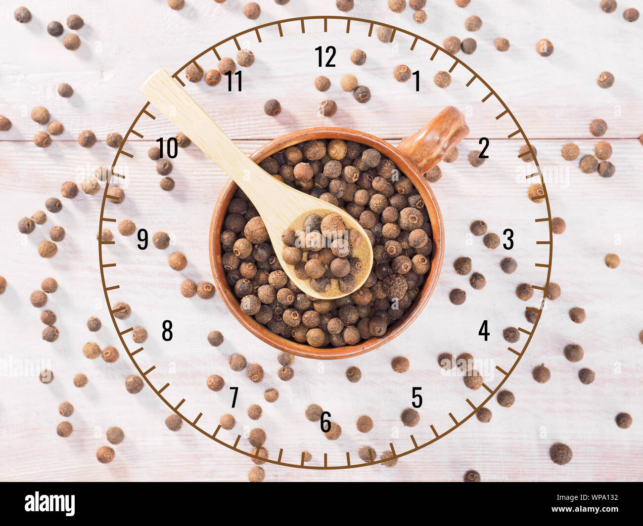Allspice (Jamaica pepper) as background for clock. Eating spices ...