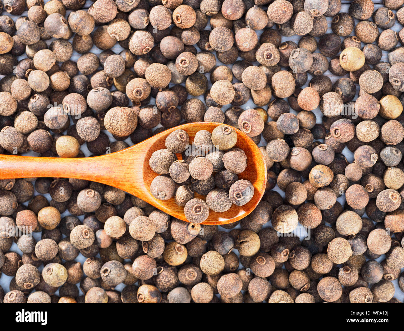Allspice (Jamaica pepper) in a wooden spoon horizontally Stock Photo ...