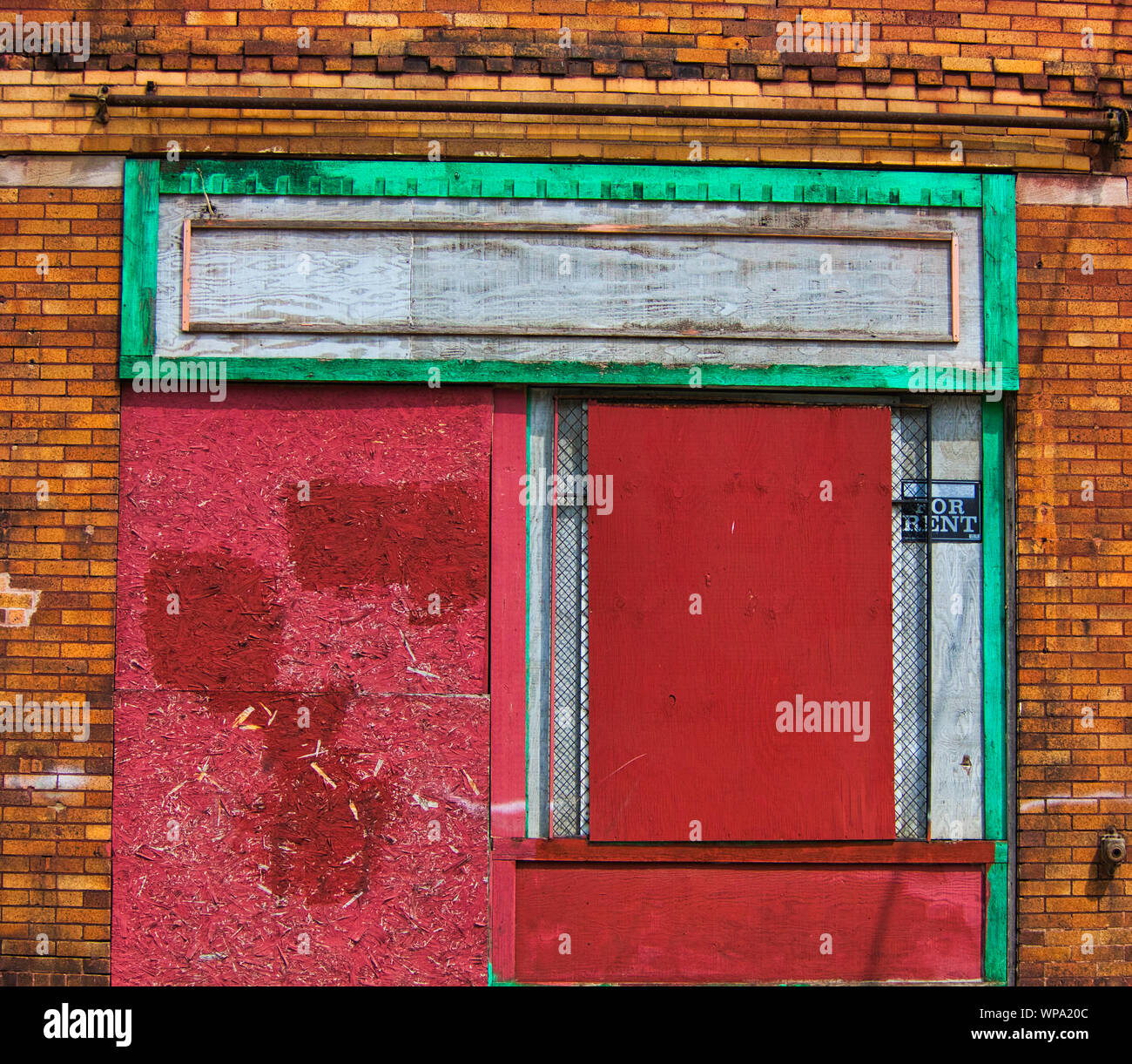 Boarded up store front of a brick building Stock Photo - Alamy