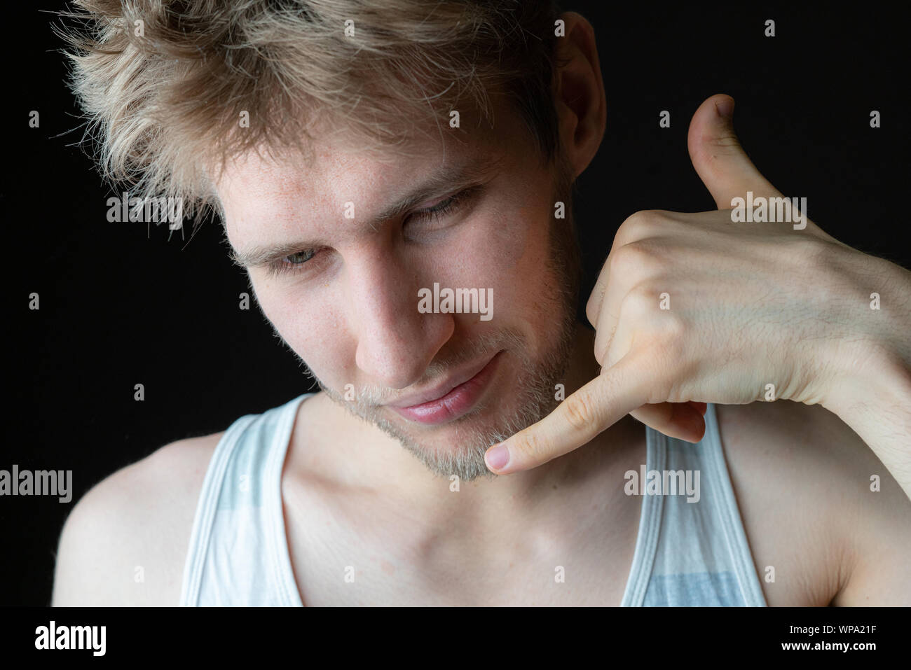 young guy showing a call me sign gesture finger, symbol of mobile ...