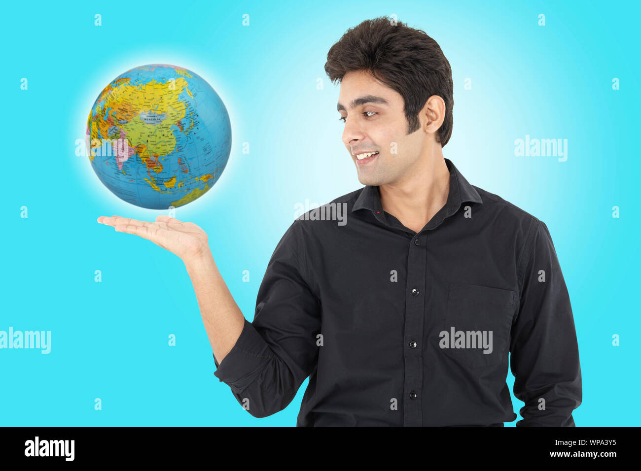 Business man holding atlas globe hi-res stock photography and images ...