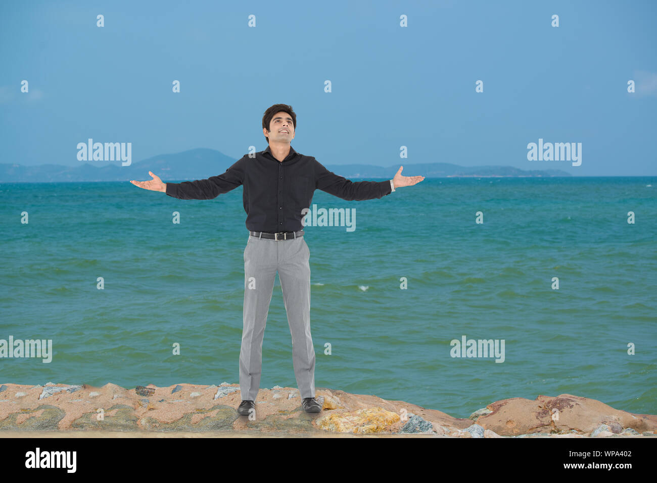 Man arms outstretched sea hi-res stock photography and images - Alamy