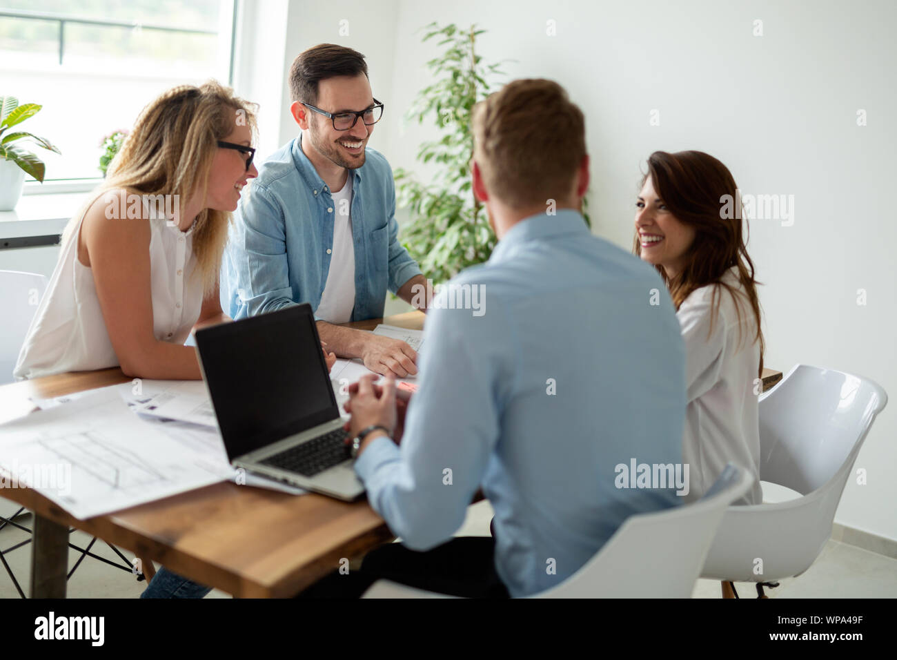 Group of business people working and communicating while sitting at the ...