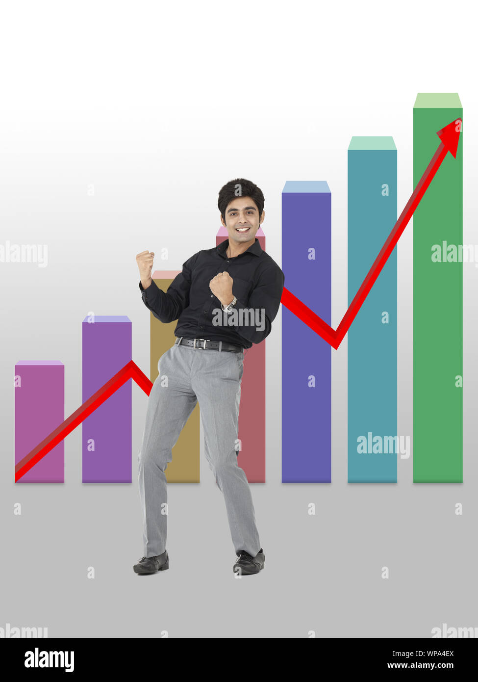 Businessman celebrating success against bar graph Stock Photo - Alamy