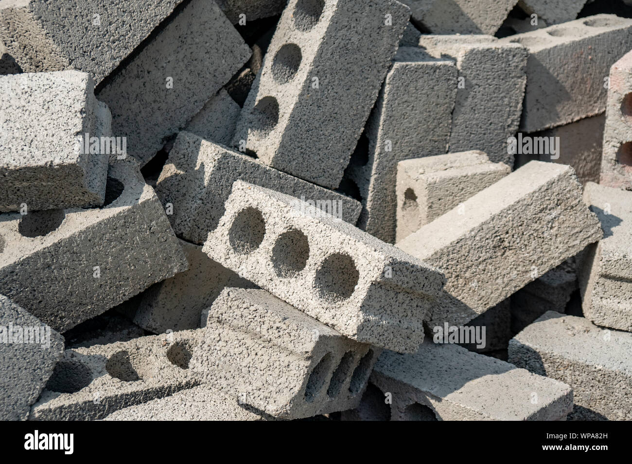 stacks of gray concrete blocks on the ground. Building Stock Photo - Alamy