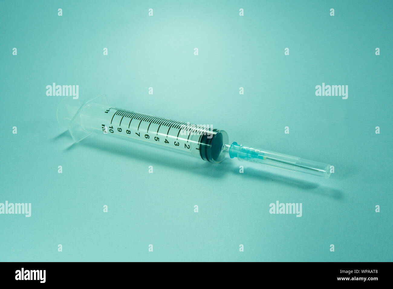 Medical syringe on a blue background. Isolated image of a medical ...