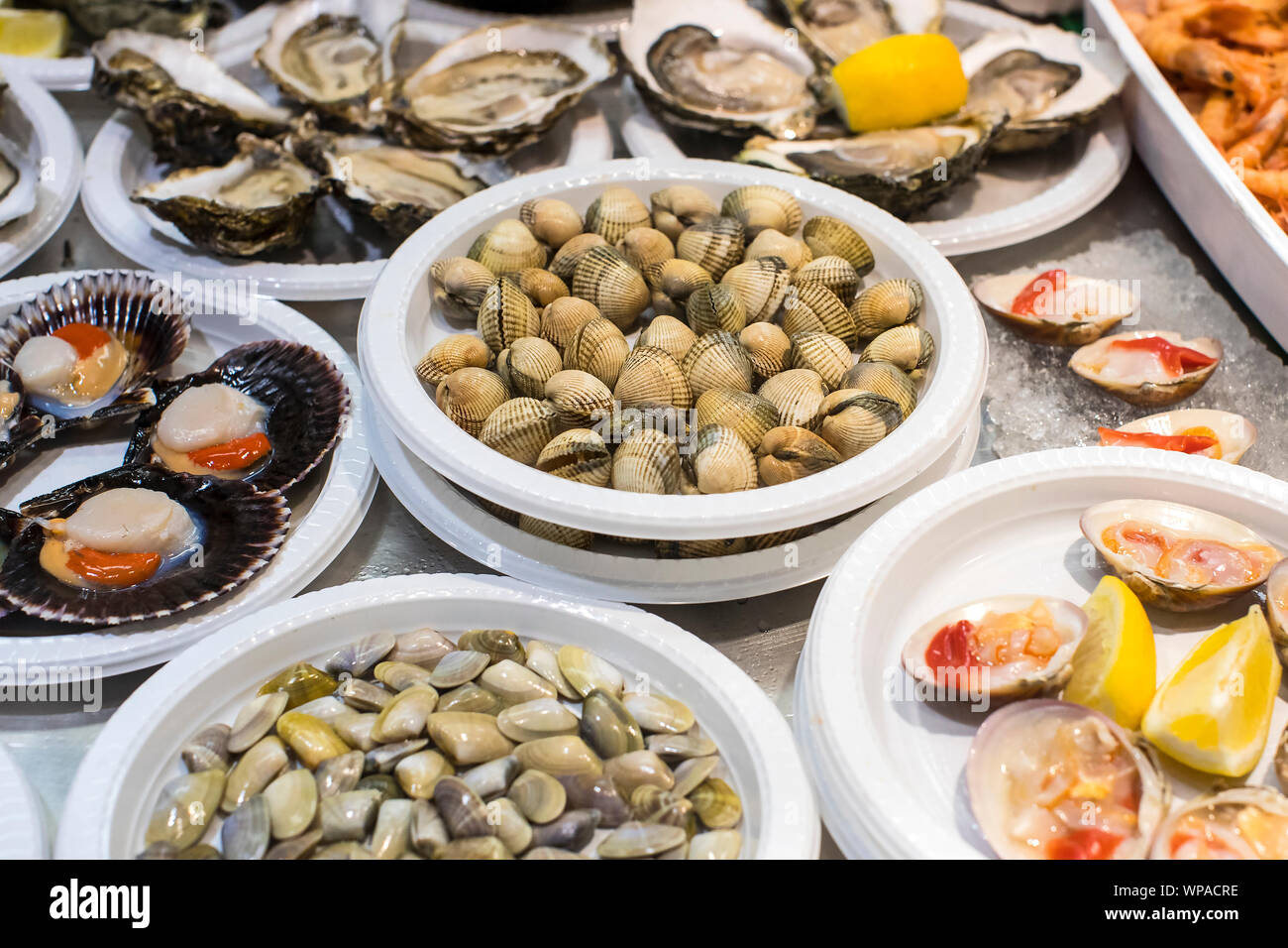 seafood on a plastic plate shrimp scallops Stock Photo - Alamy