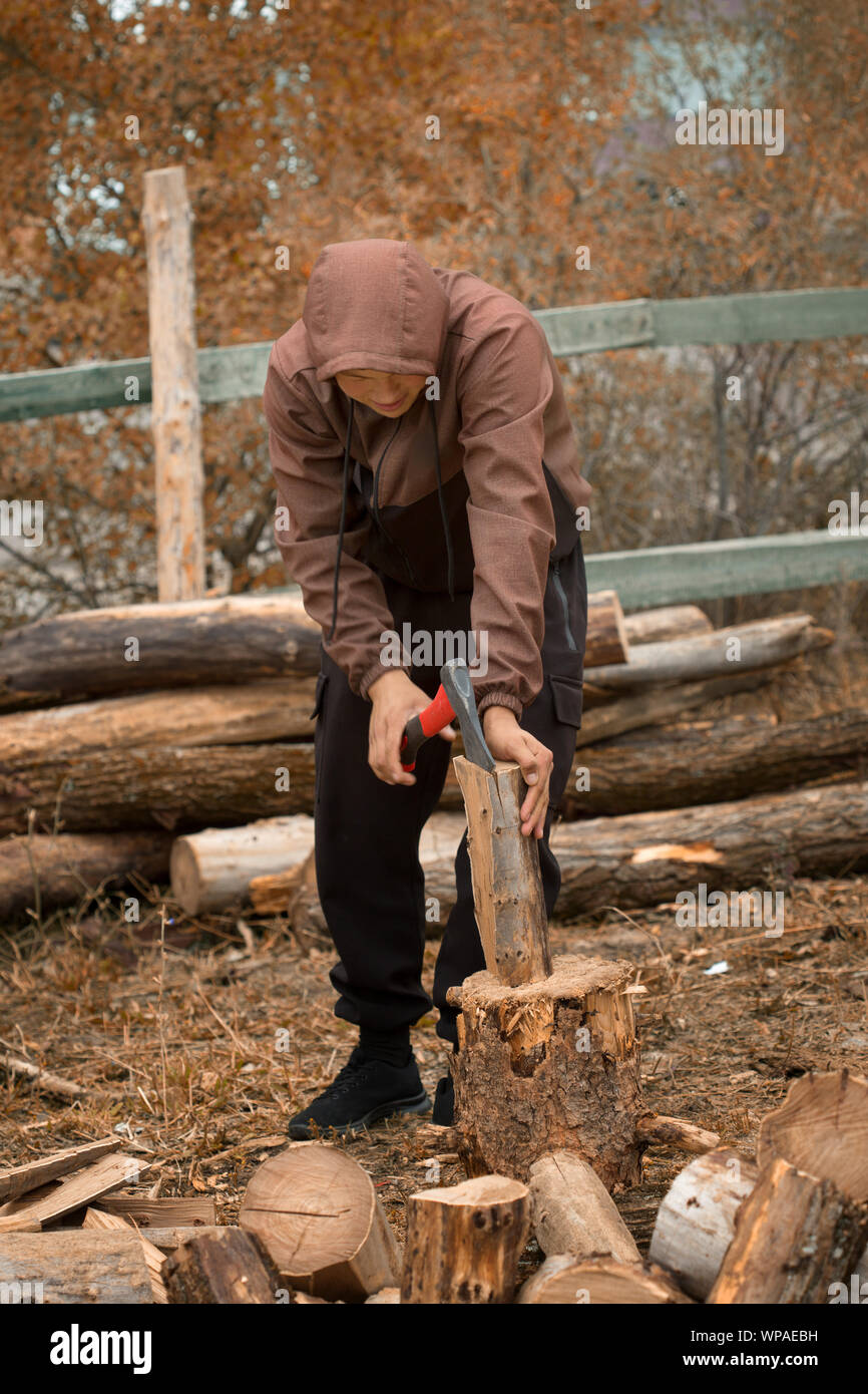 Man choping wood in the forest Stock Photo - Alamy