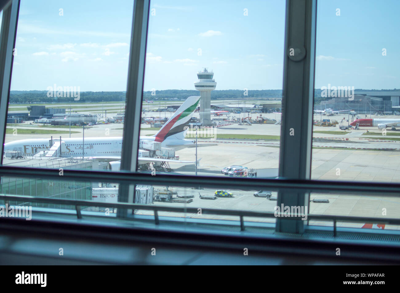 Tail fin of Emirates A380 airbus with a background of London Gatwick ...