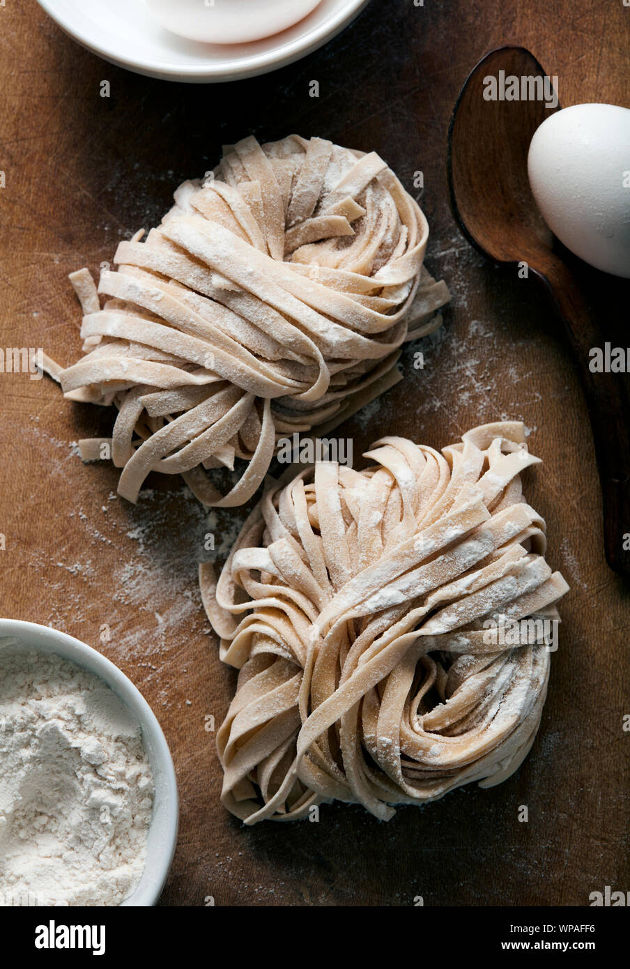 Homemade fresh pasta rolled and drying on cutting board Stock Photo - Alamy