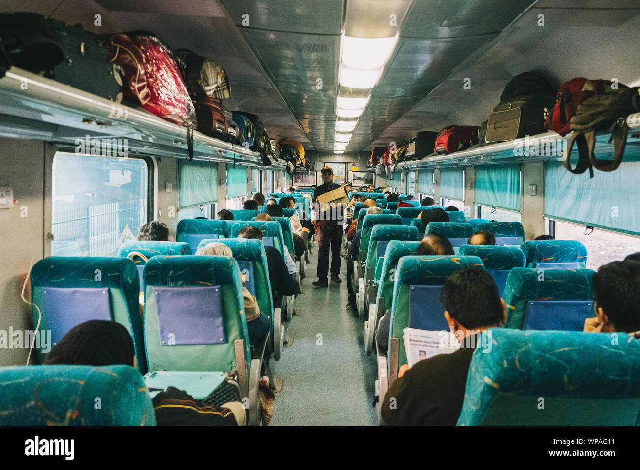 Man serving food and beverage to passengers on train from New Delhi to Kalka, India Stock Photo ...